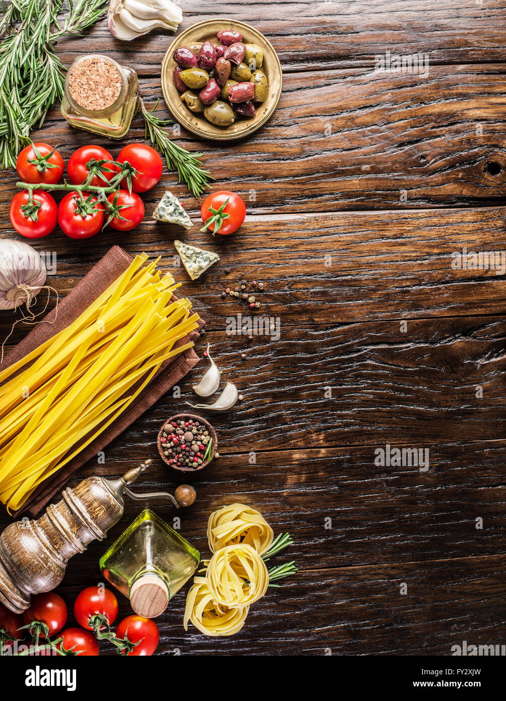 Pasta ingredients. Cherry-tomatoes, spaghetti pasta, rosemary and ...