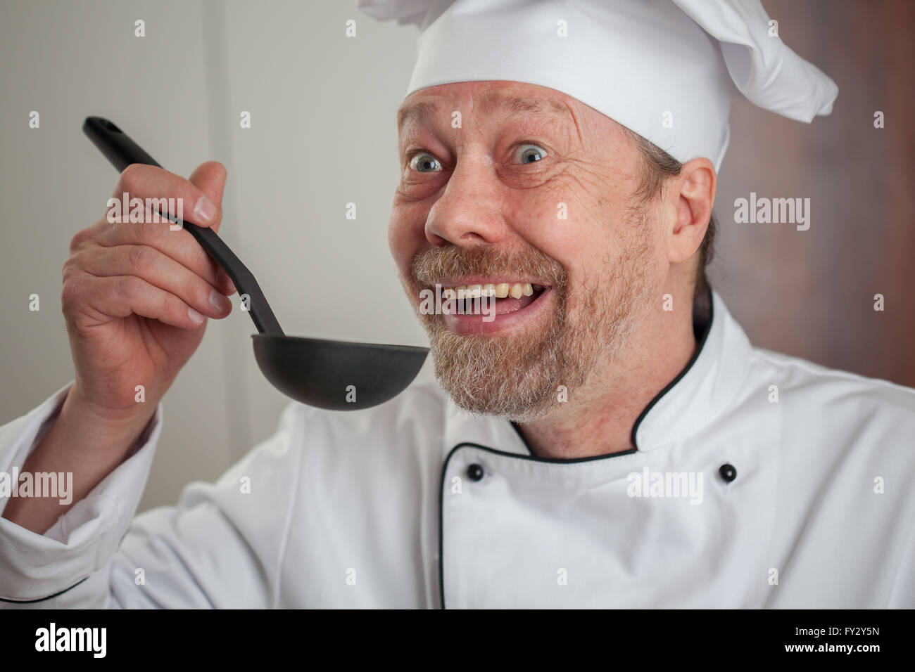 White male Cook in the kitchen with a ladle Stock Photo - Alamy