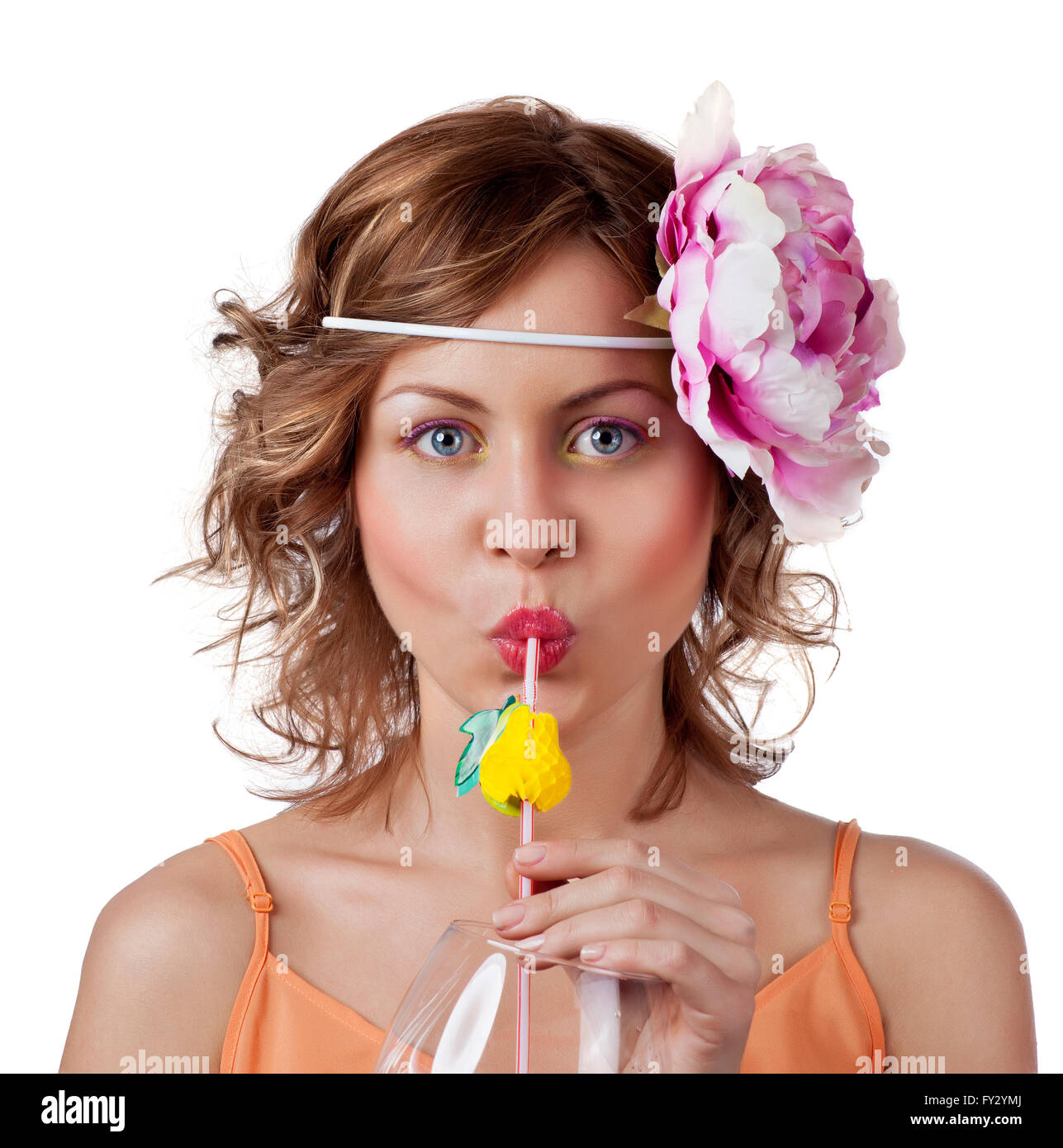 Pretty woman sipping orange juice Stock Photo - Alamy
