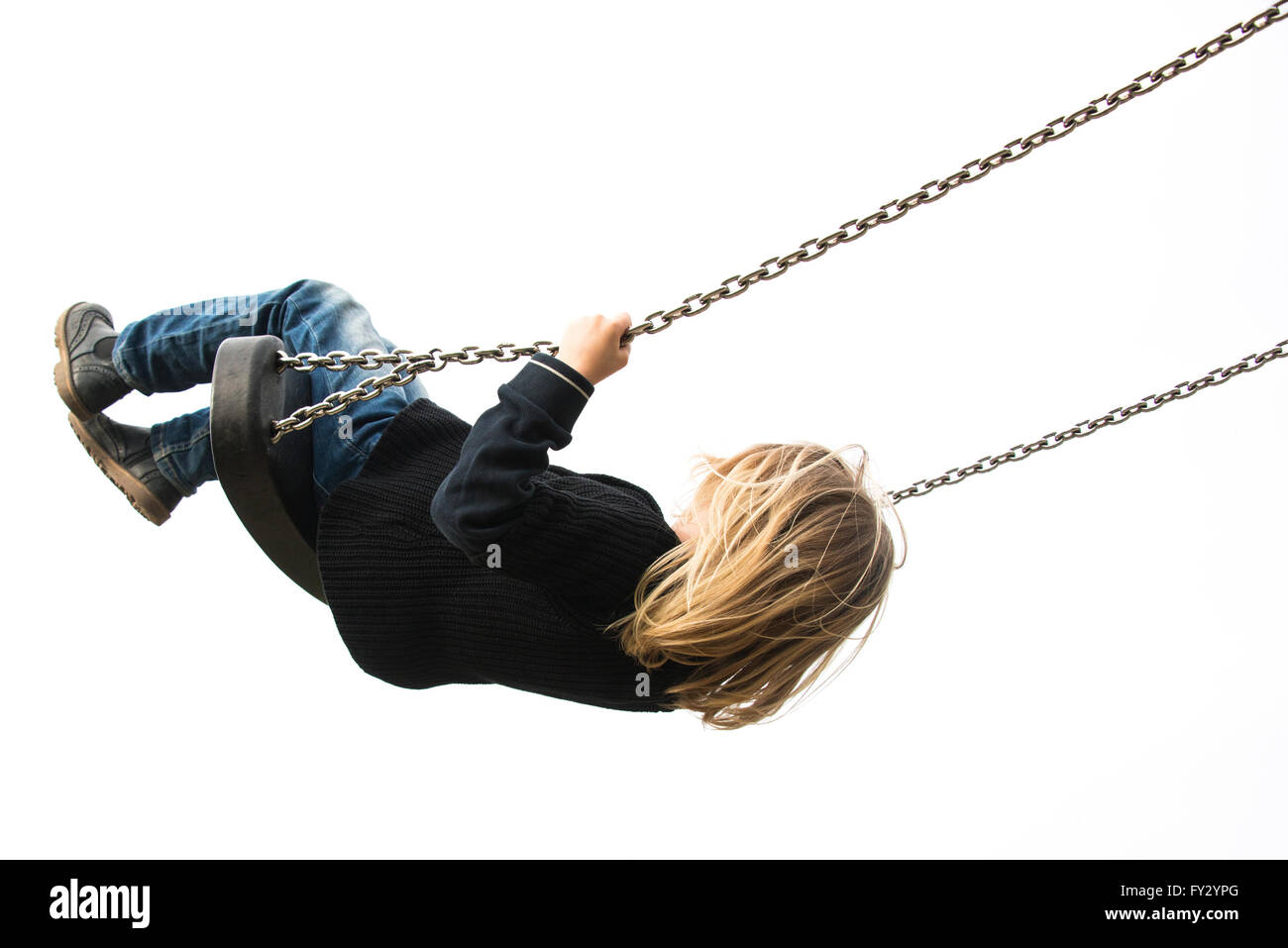 Little child blond girl having fun on a swing outdoor. Summer playground. Girl swinging high ...