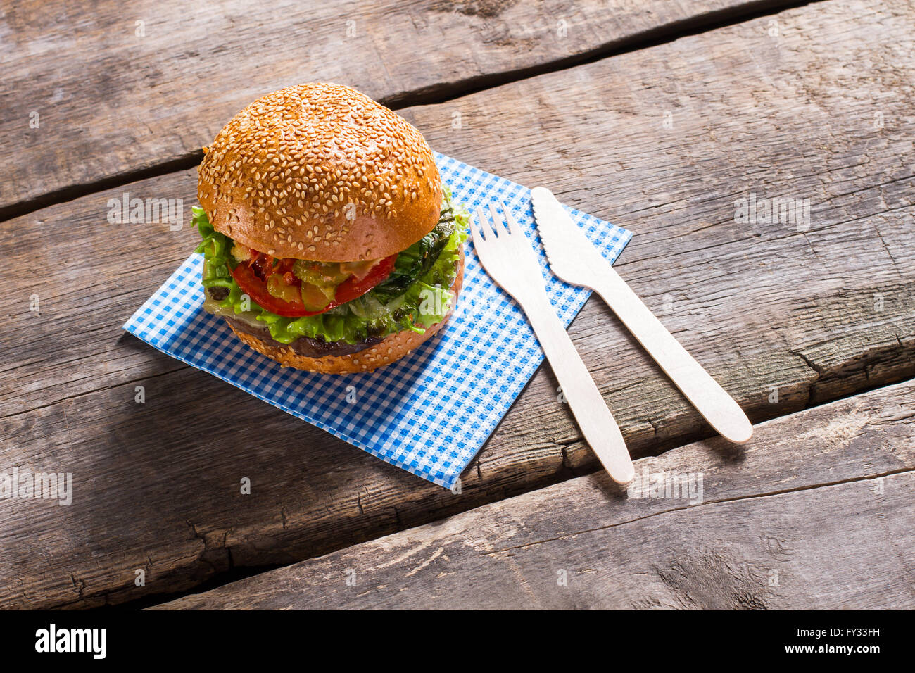 Burger with paper cutlery Stock Photo - Alamy
