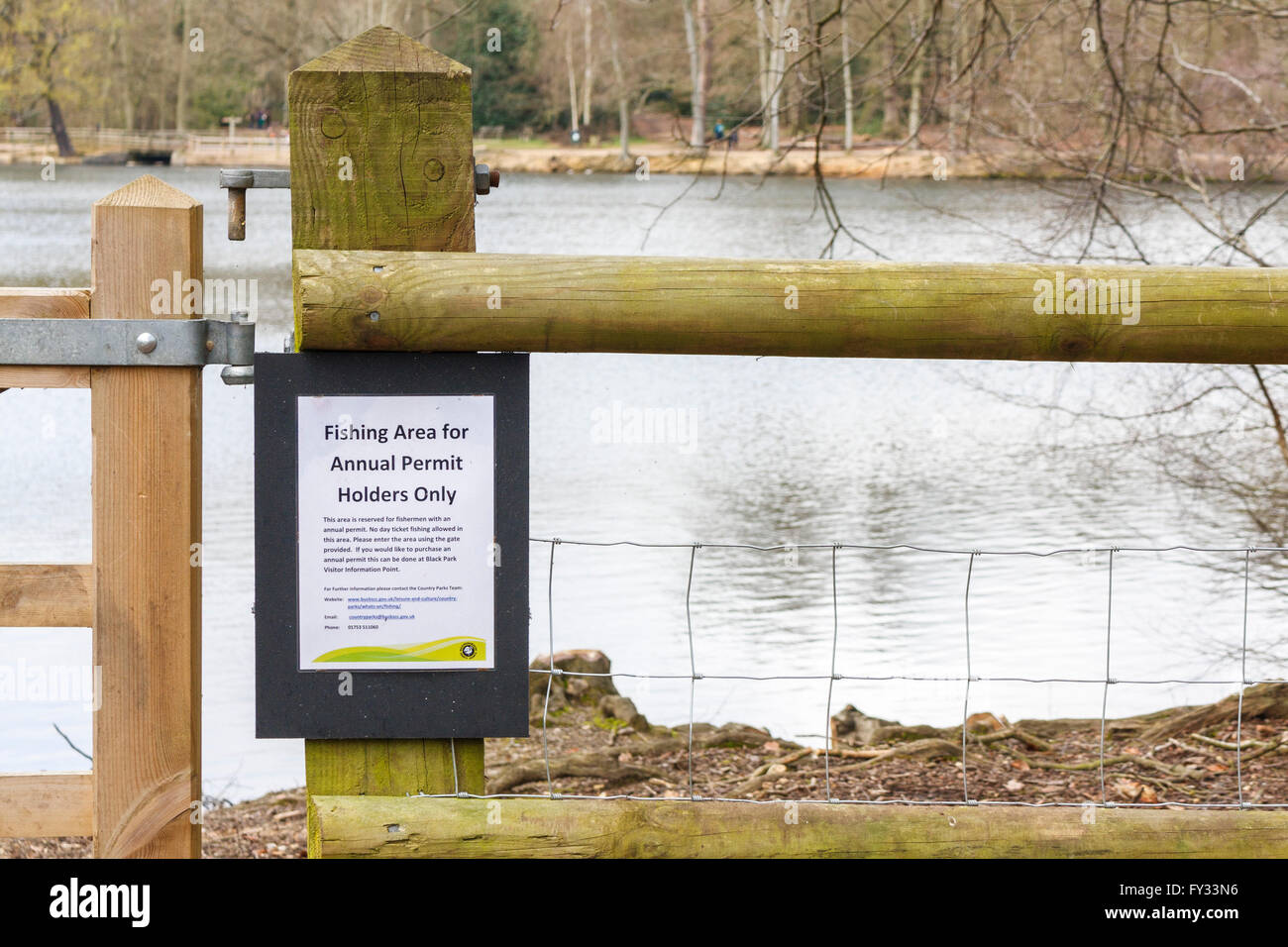 A sign on a fence displaying a 'fishing area for permit holders only ...