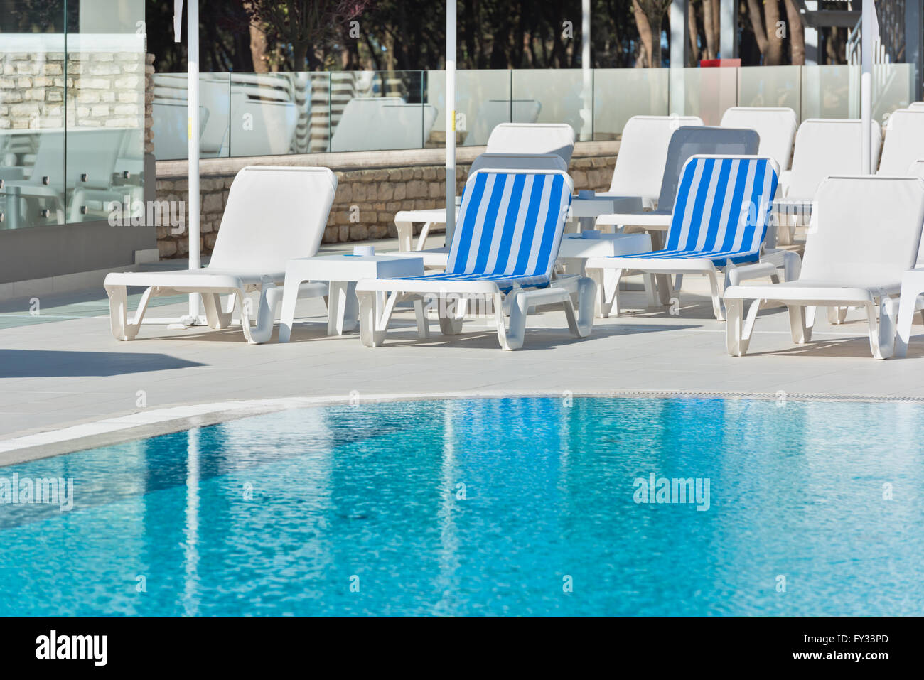 Hotel Poolside Chairs near a swimming pool. Summer shot Stock Photo - Alamy