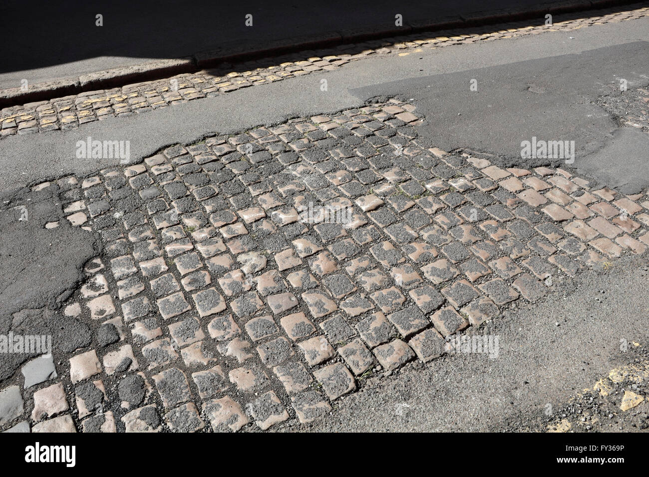 Old cobbled street under worn road surface Stock Photo - Alamy