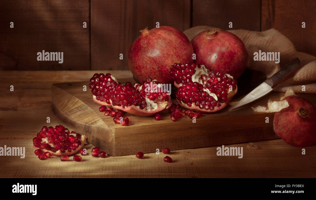 Pomegranate fruit split open revealing the juicy seed pods Stock Photo ...