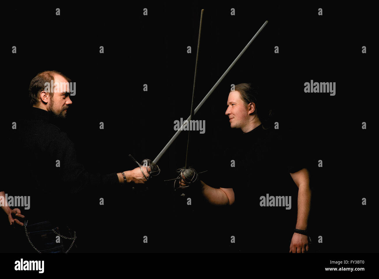 Rehearsal reenactors. Fight on swords Stock Photo - Alamy