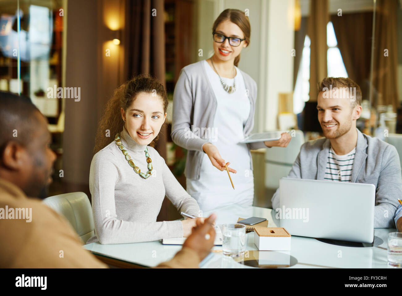Young colleagues at meeting Stock Photo - Alamy