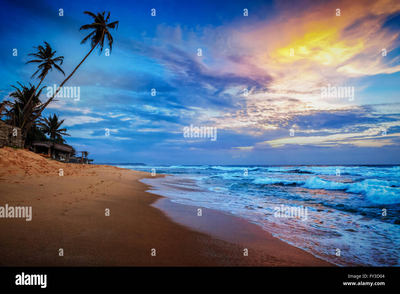 Sunset on tropical beach Stock Photo - Alamy