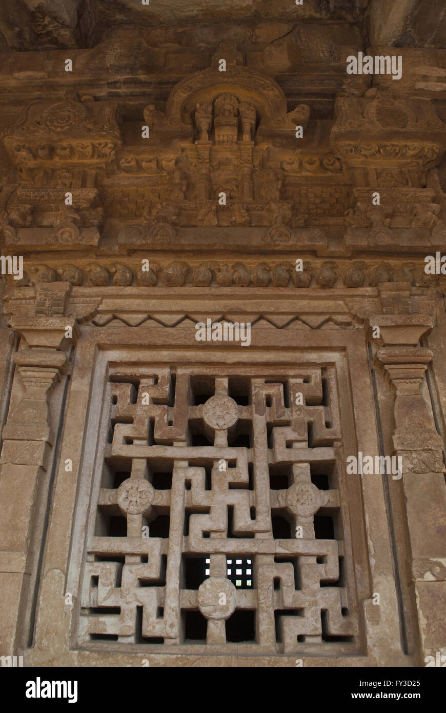 Carved window with the swastika design on the garbha griha wall, Aihole ...