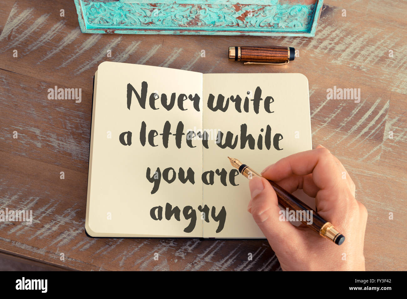 Handwritten quote Never write a letter while you are angry Stock Photo ...