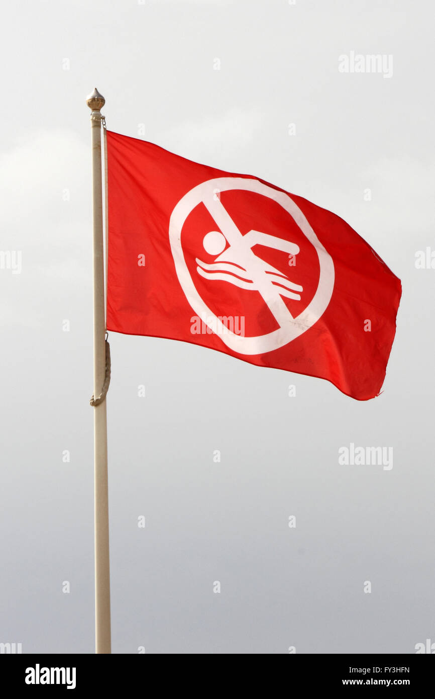 Red flag with white "No Swimming" motif Stock Photo - Alamy