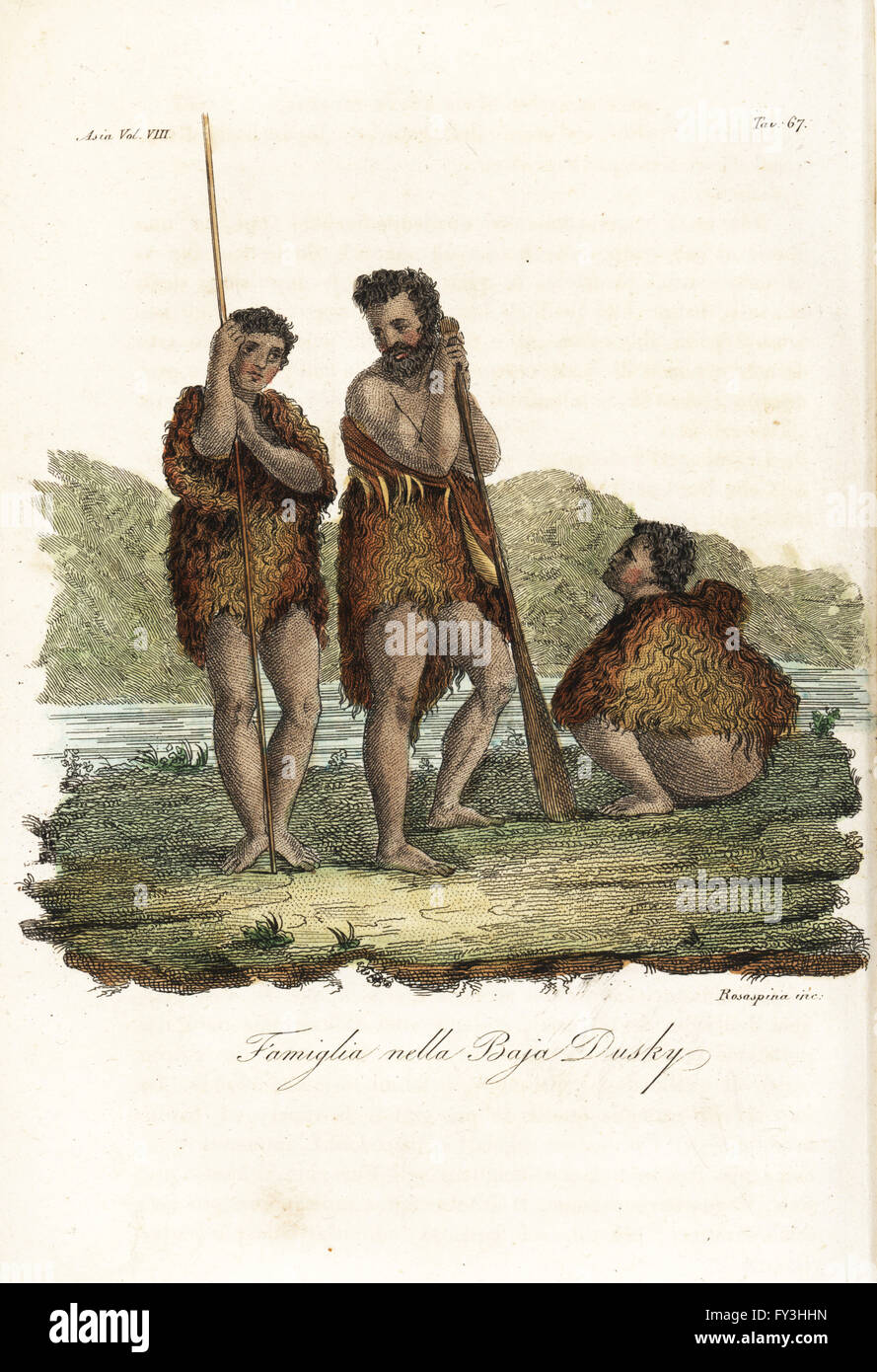 Maori family in Dusky Bay, New Zealand. The man holds a taiaha club ...