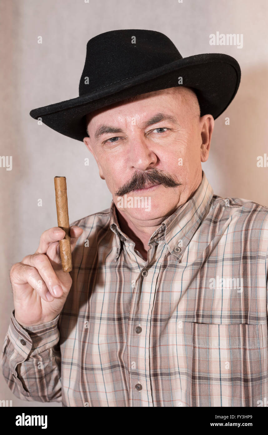 Cowboy with mustache smoking cigar hi-res stock photography and images ...