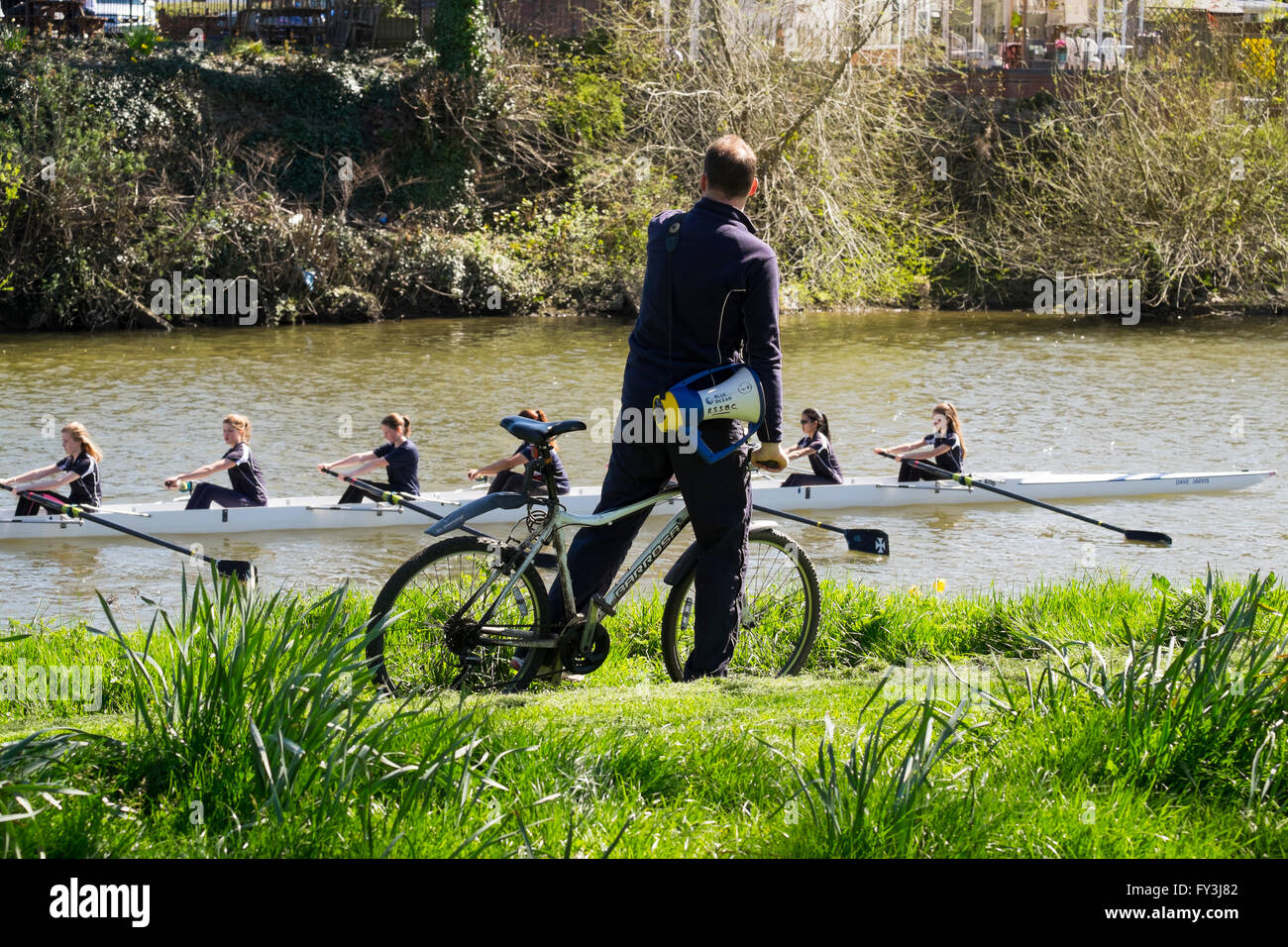 A rowing instructor watching a team of female rowers on the River ...