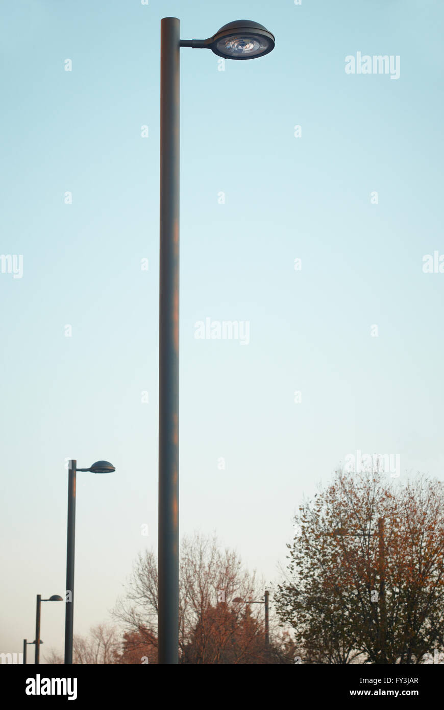 Modern street lamps at sunrise. Vertical format Stock Photo - Alamy