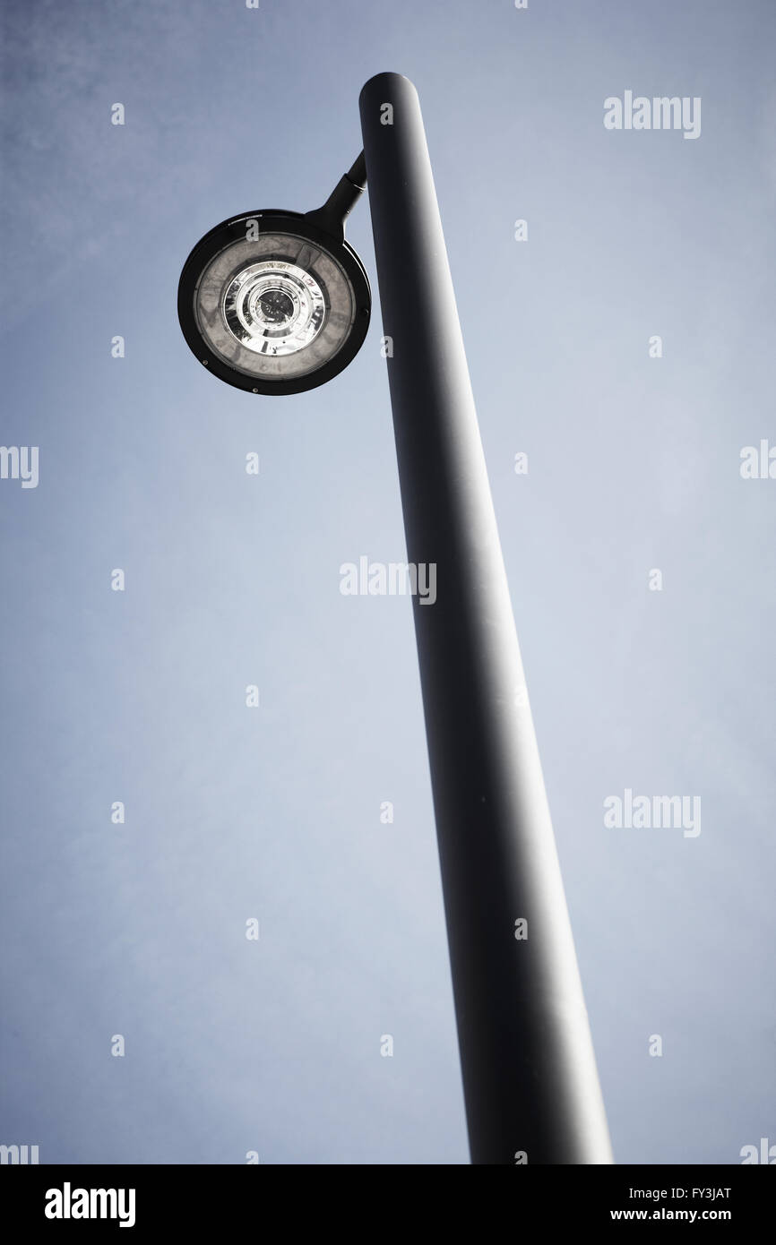 Modern street lamp under a blue sky. Vertical format Stock Photo - Alamy