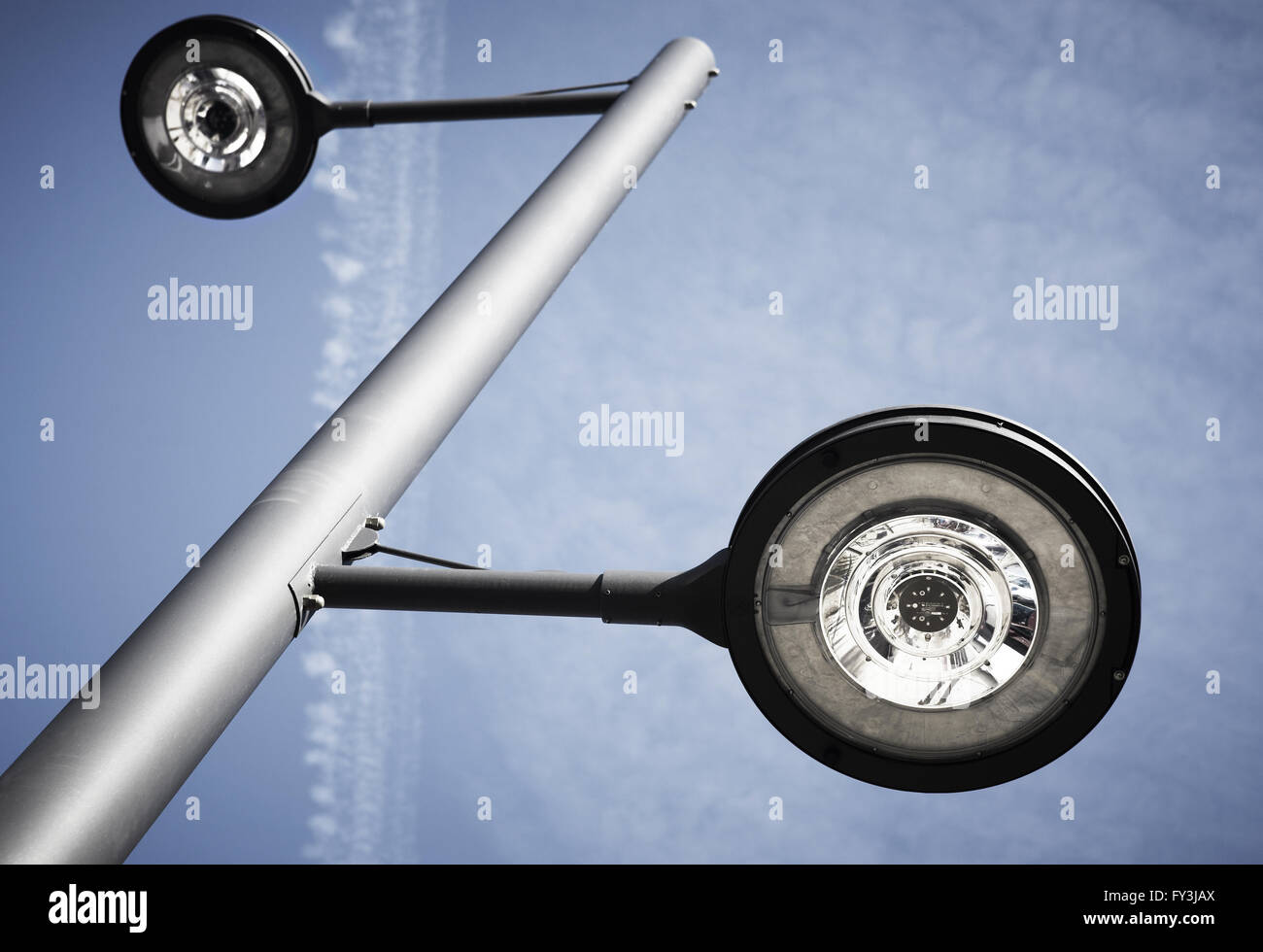 Modern street lamp under a blue sky. Vertical format Stock Photo - Alamy