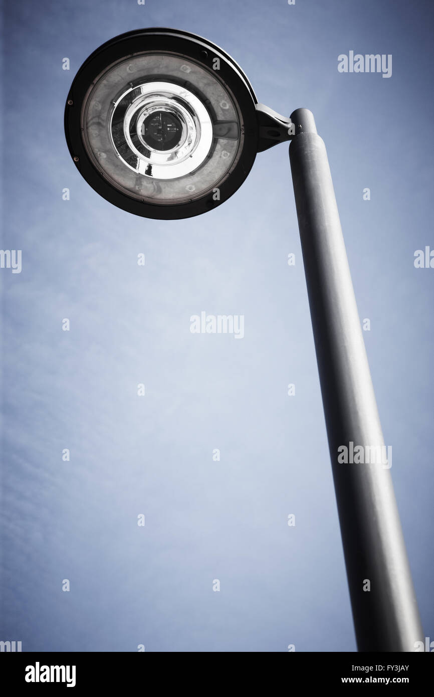 Modern street lamp under a blue sky. Vertical format Stock Photo - Alamy