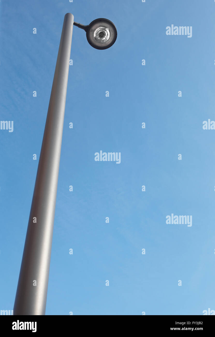 Modern street lamp under a blue sky. Vertical format Stock Photo - Alamy