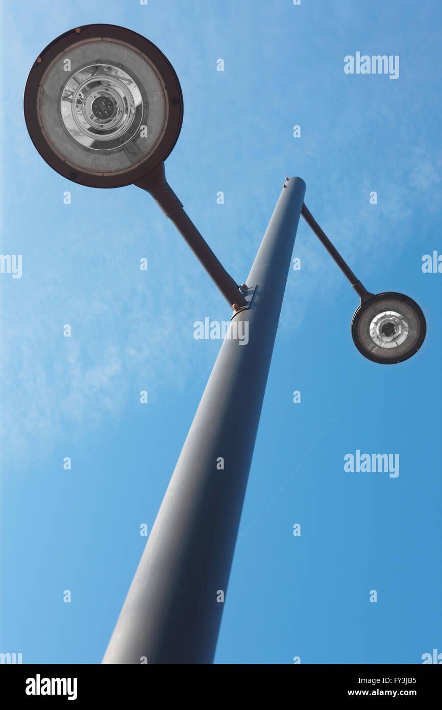 Modern street lamp under a blue sky. Vertical format Stock Photo - Alamy
