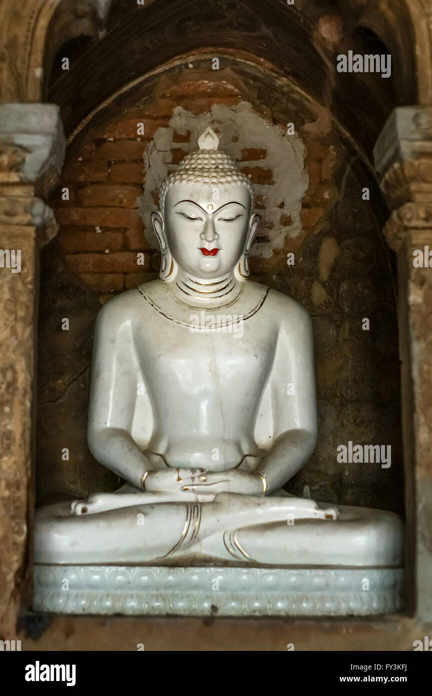 White Buddha marble in meditation posture with golden third eye Stock ...
