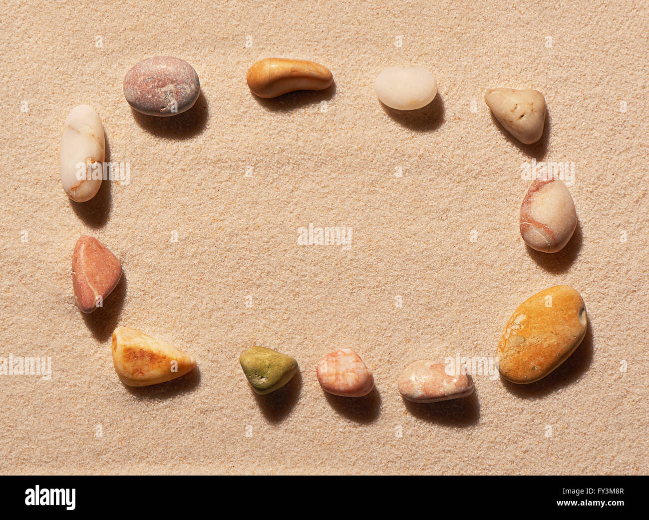Rectangular frame of sea stones on sand. Summer beach background. View ...