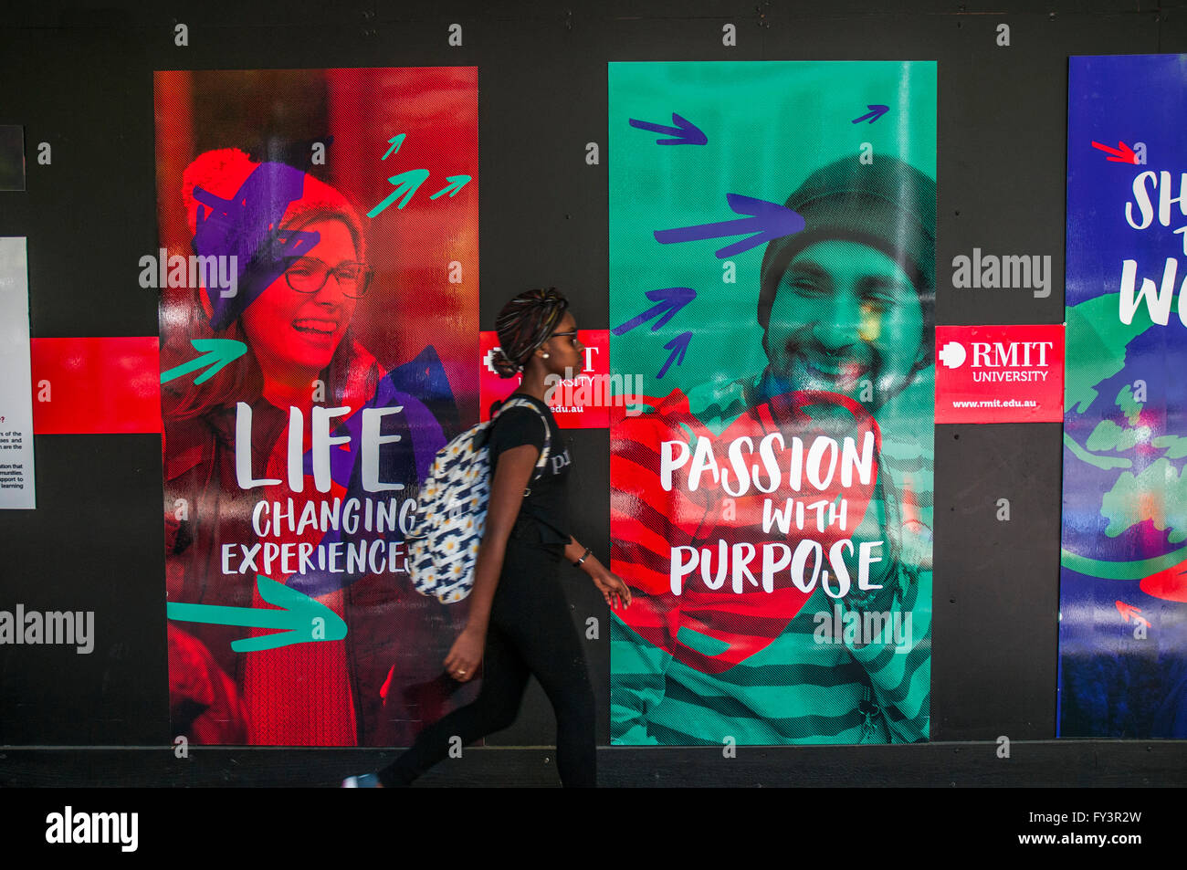 A student walks past promotional banners on the RMIT University ...