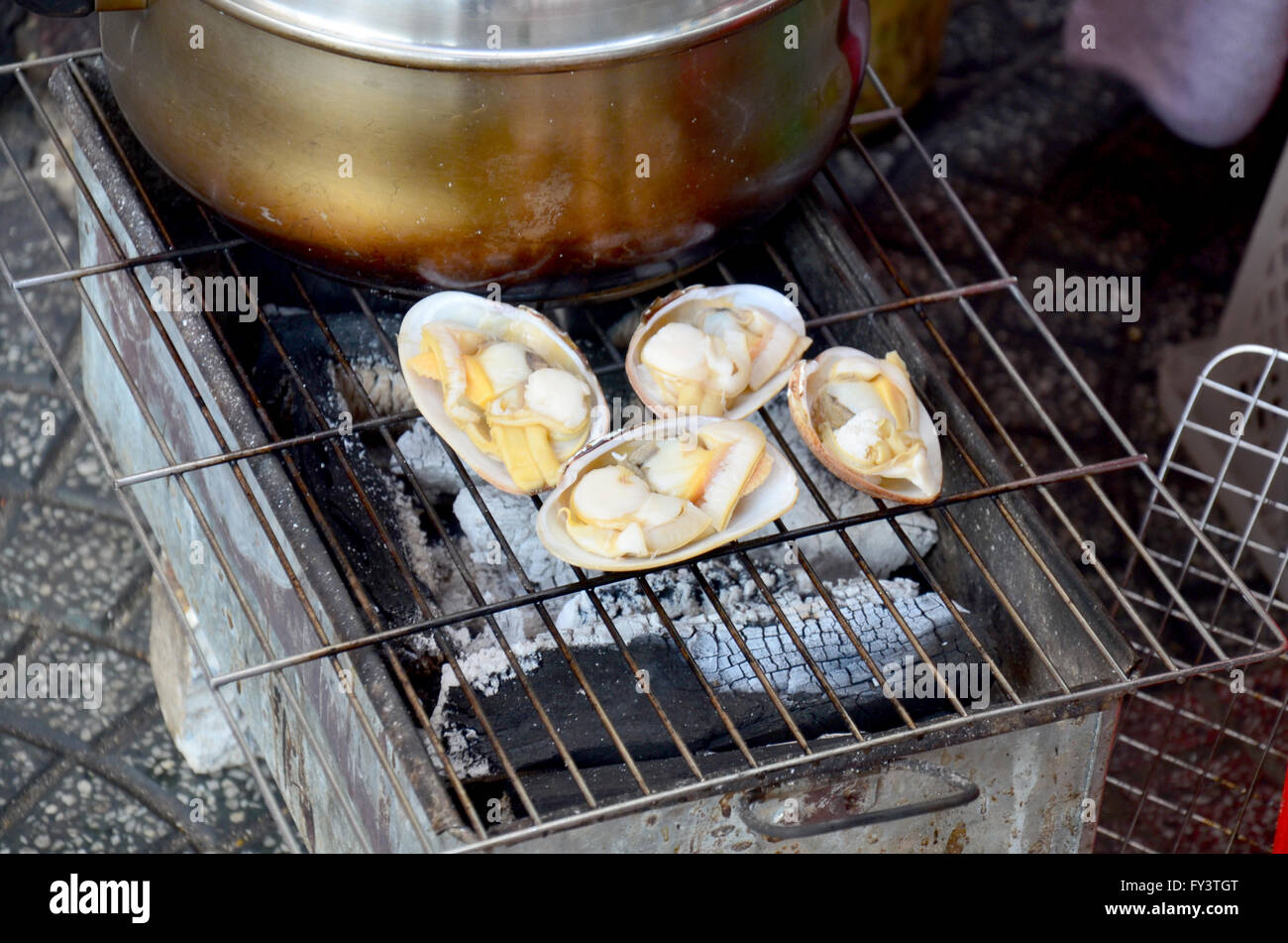 Vietnmese people cooking shell for sale on street at Saigon city on ...