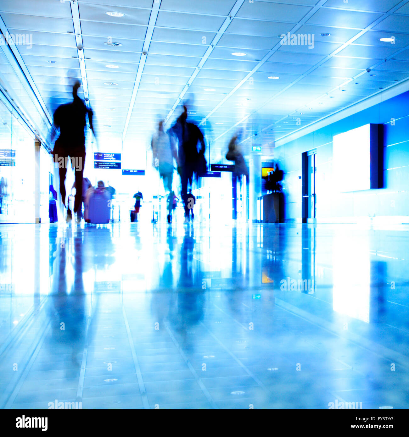 Passengers walking in contemporary hallway of airport Stock Photo - Alamy