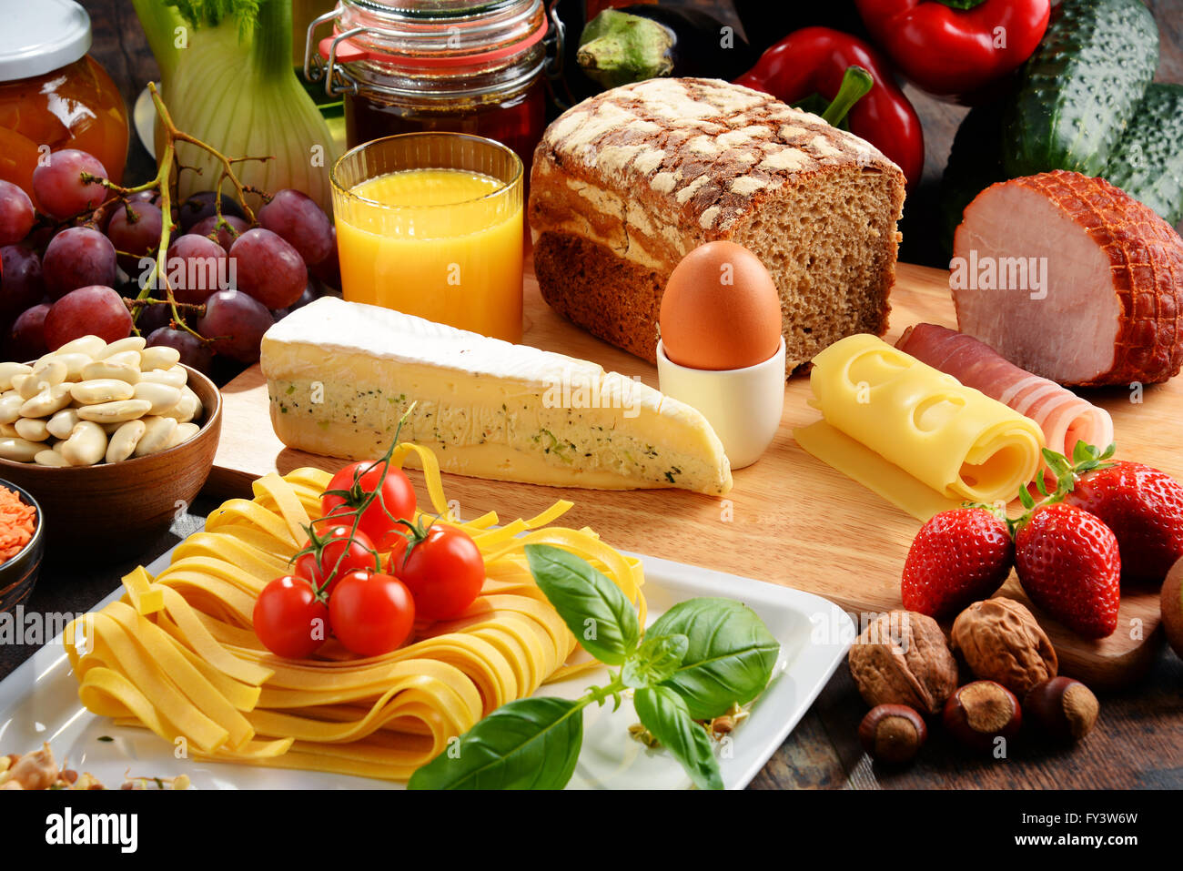 Composition with variety of organic food products on kitchen table ...