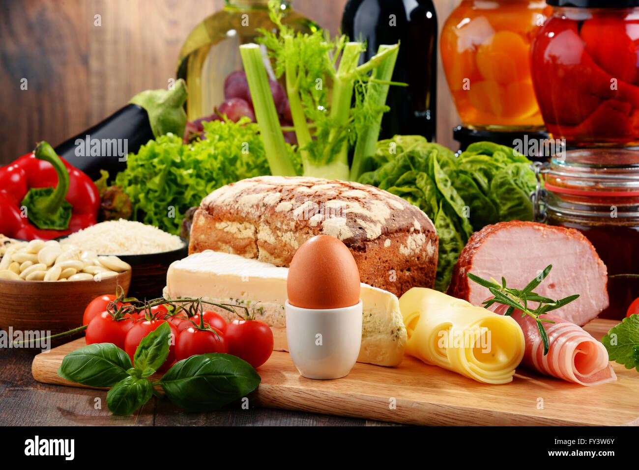 Composition with variety of organic food products on kitchen table ...
