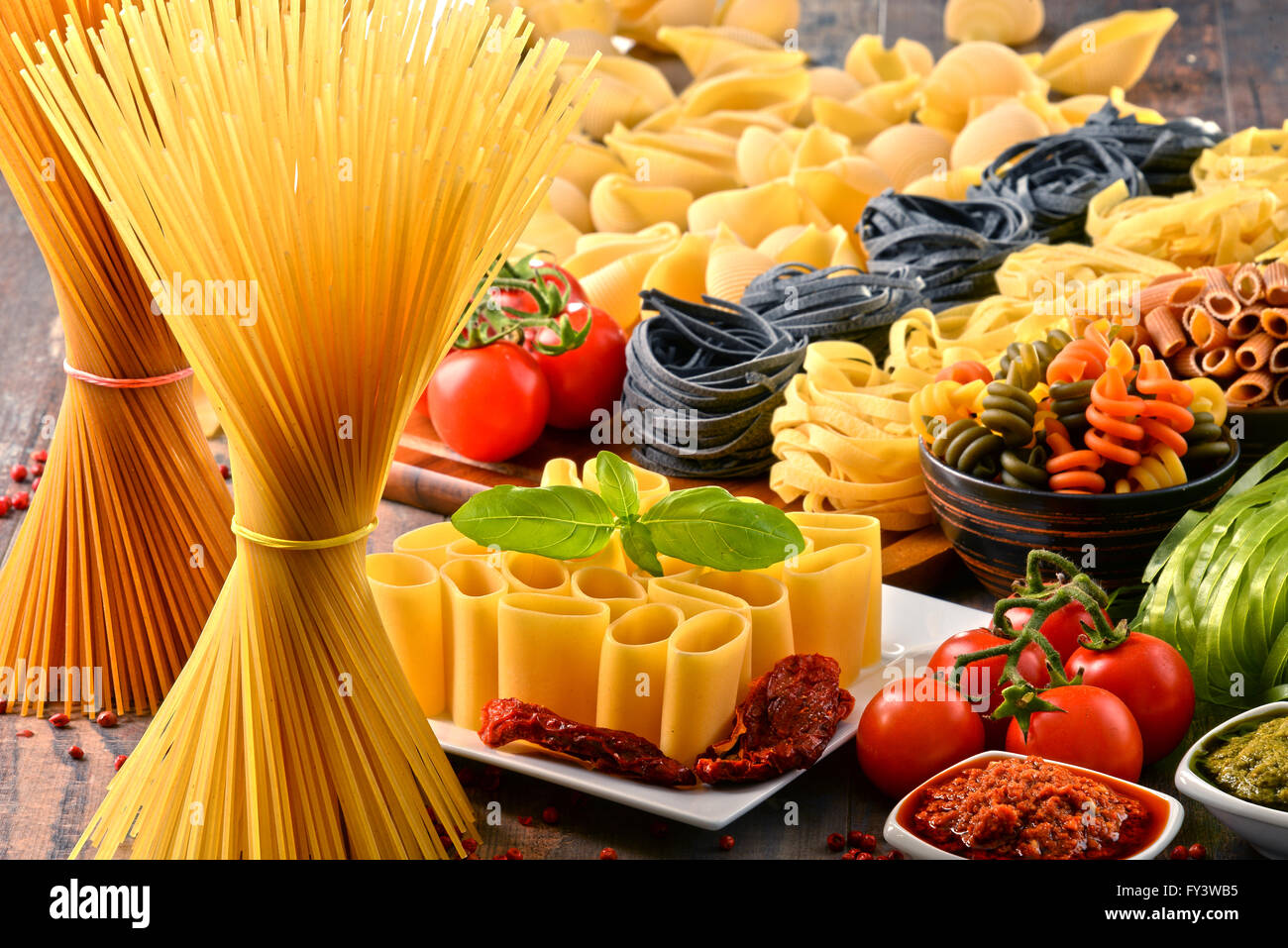 Composition with variety of pasta on kitchen table Stock Photo - Alamy