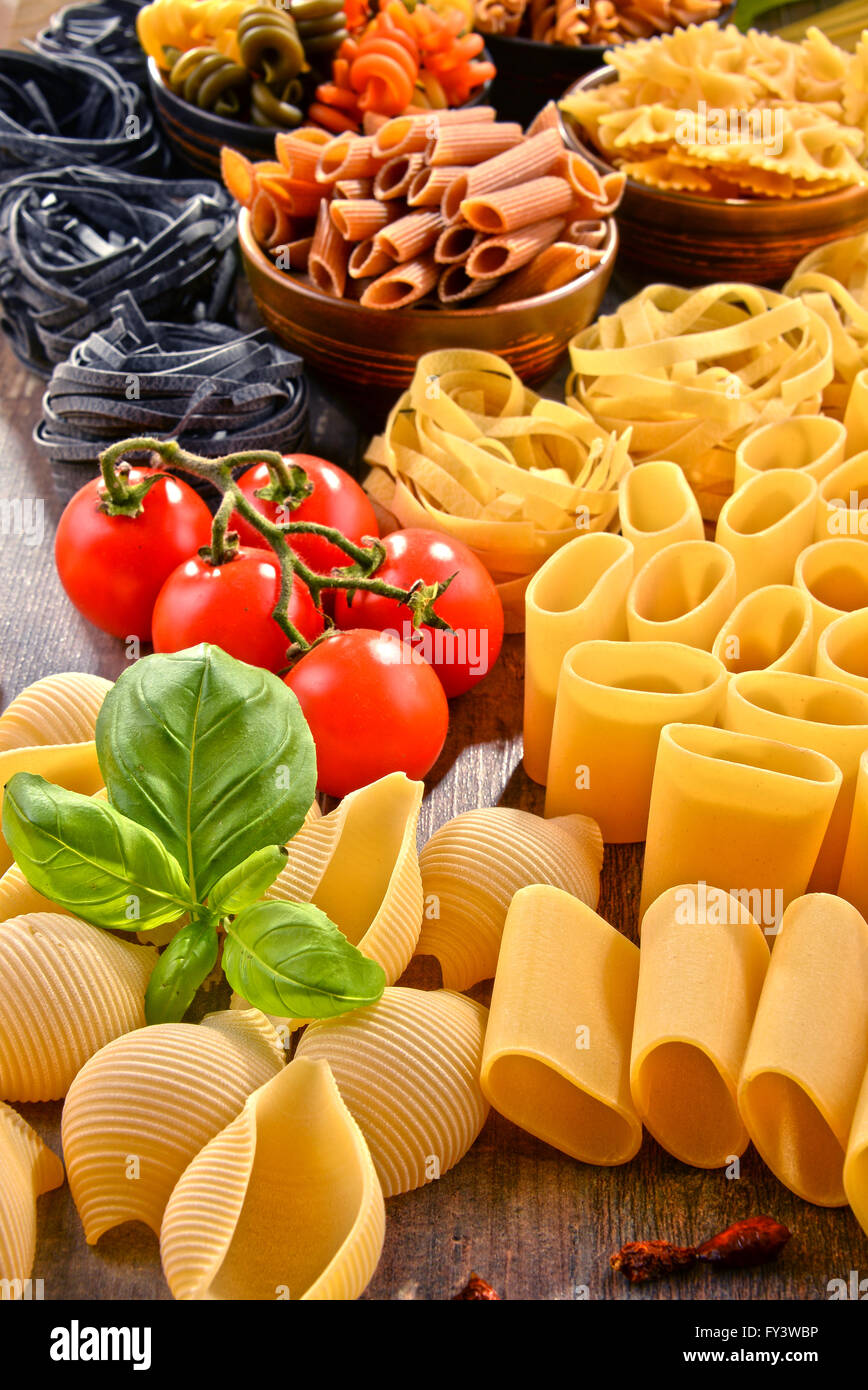 Composition with variety of pasta on kitchen table Stock Photo - Alamy