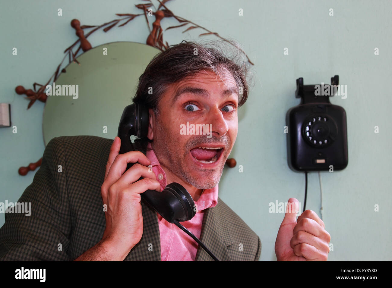 smiling man answering an old fashioned telephone Stock Photo - Alamy