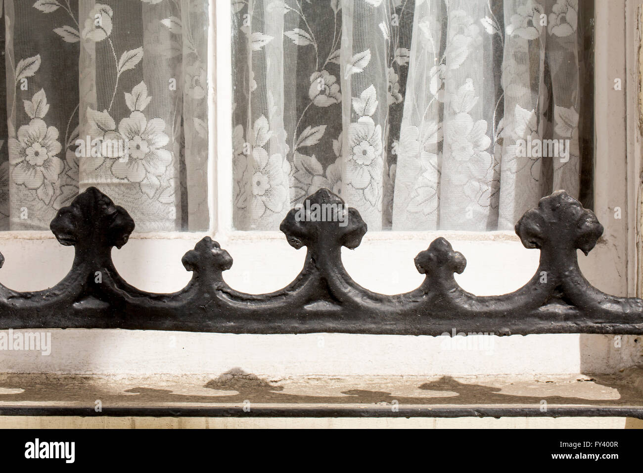 Delicate Curtain, Black Railing. A delicate curtain covers a window ...