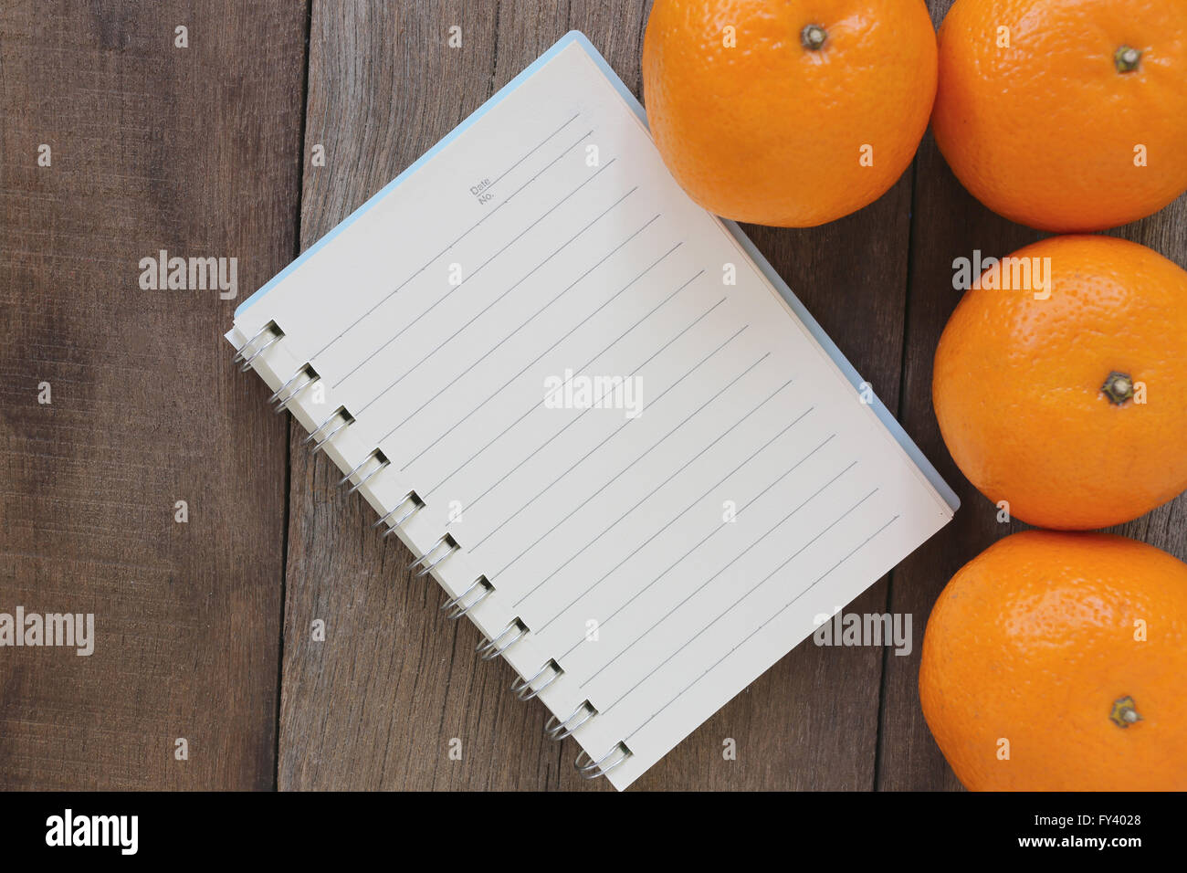Notebook and Mandarin oranges placed on the old wooden floor,design ...