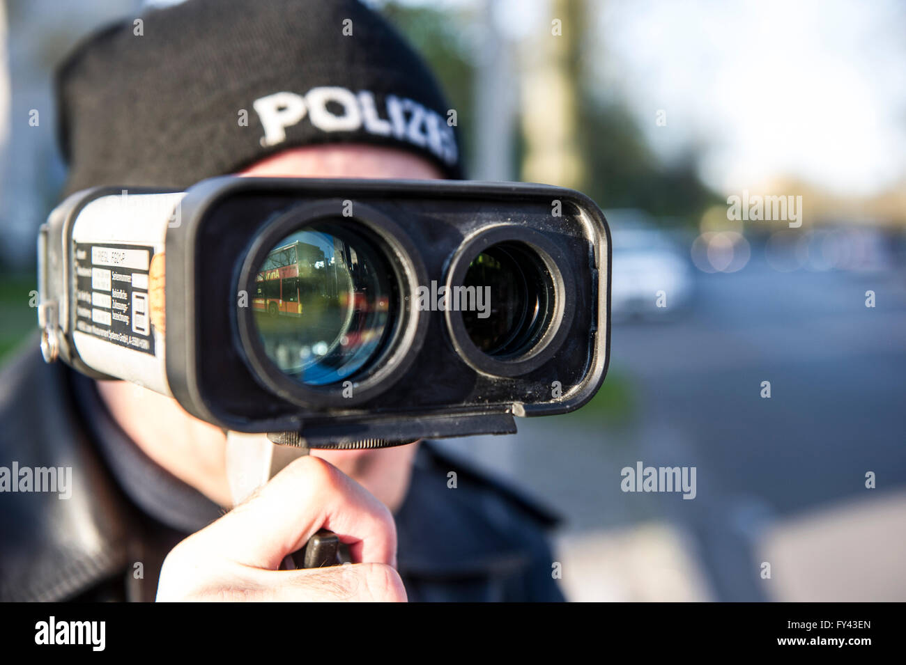 Berlin, Germany. 21st Apr, 2016. A police officer looks through a speed ...