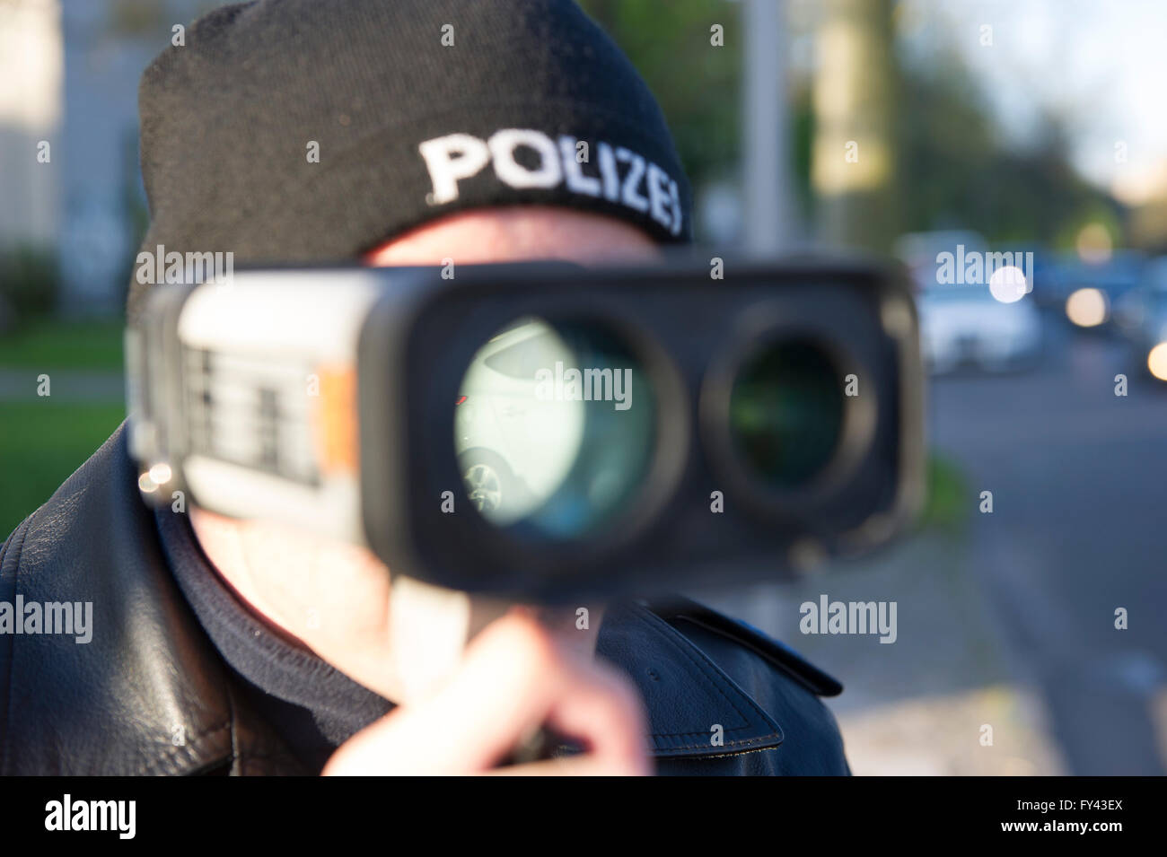 Berlin, Germany. 21st Apr, 2016. A police officer looks through a speed ...