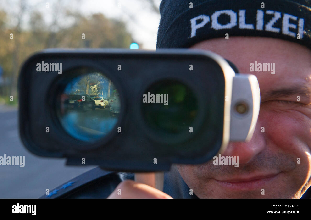 Berlin, Germany. 21st Apr, 2016. A police officer looks through a speed ...