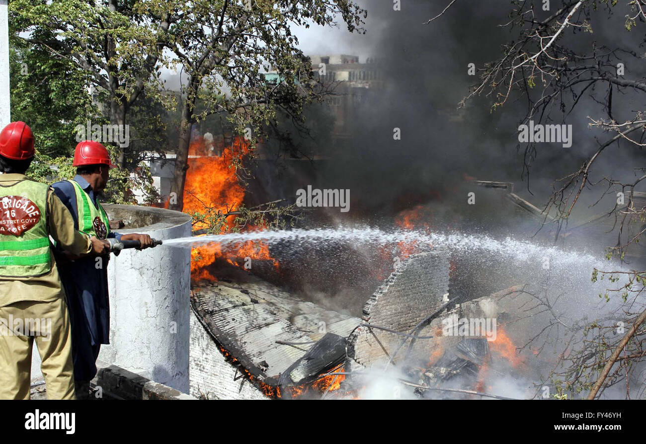 Fire fighters extinguishing from burning factory building while heavy ...