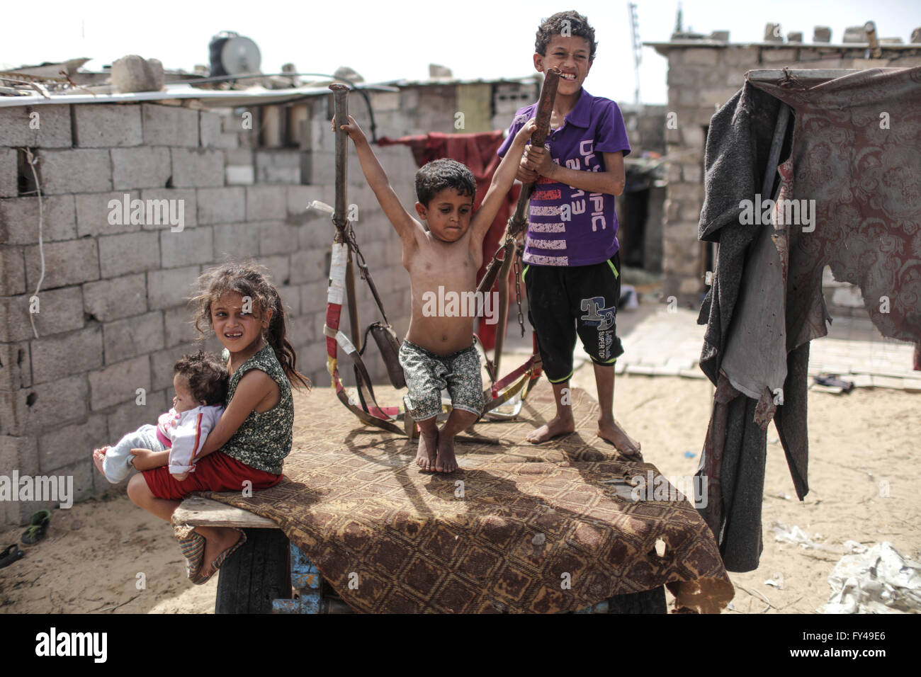 Gaza. 21st Apr, 2016. Palestinian children play in front of their house ...