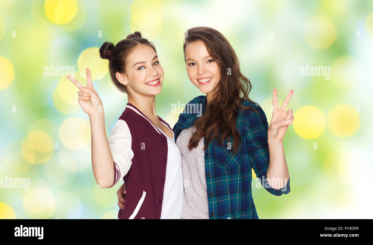 happy teenage girls hugging and showing peace sign Stock Photo - Alamy