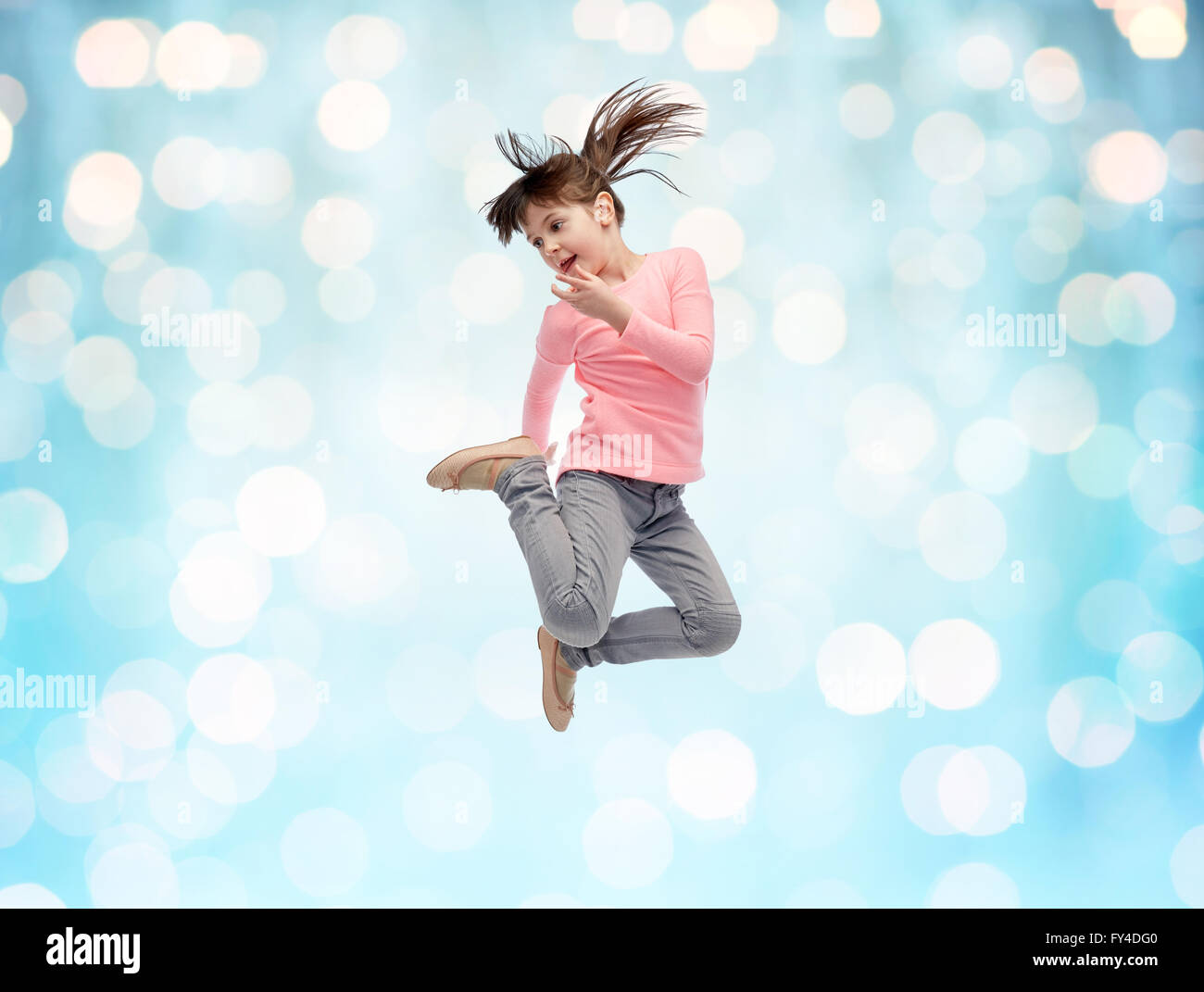 happy little girl jumping in air over blue lights Stock Photo - Alamy