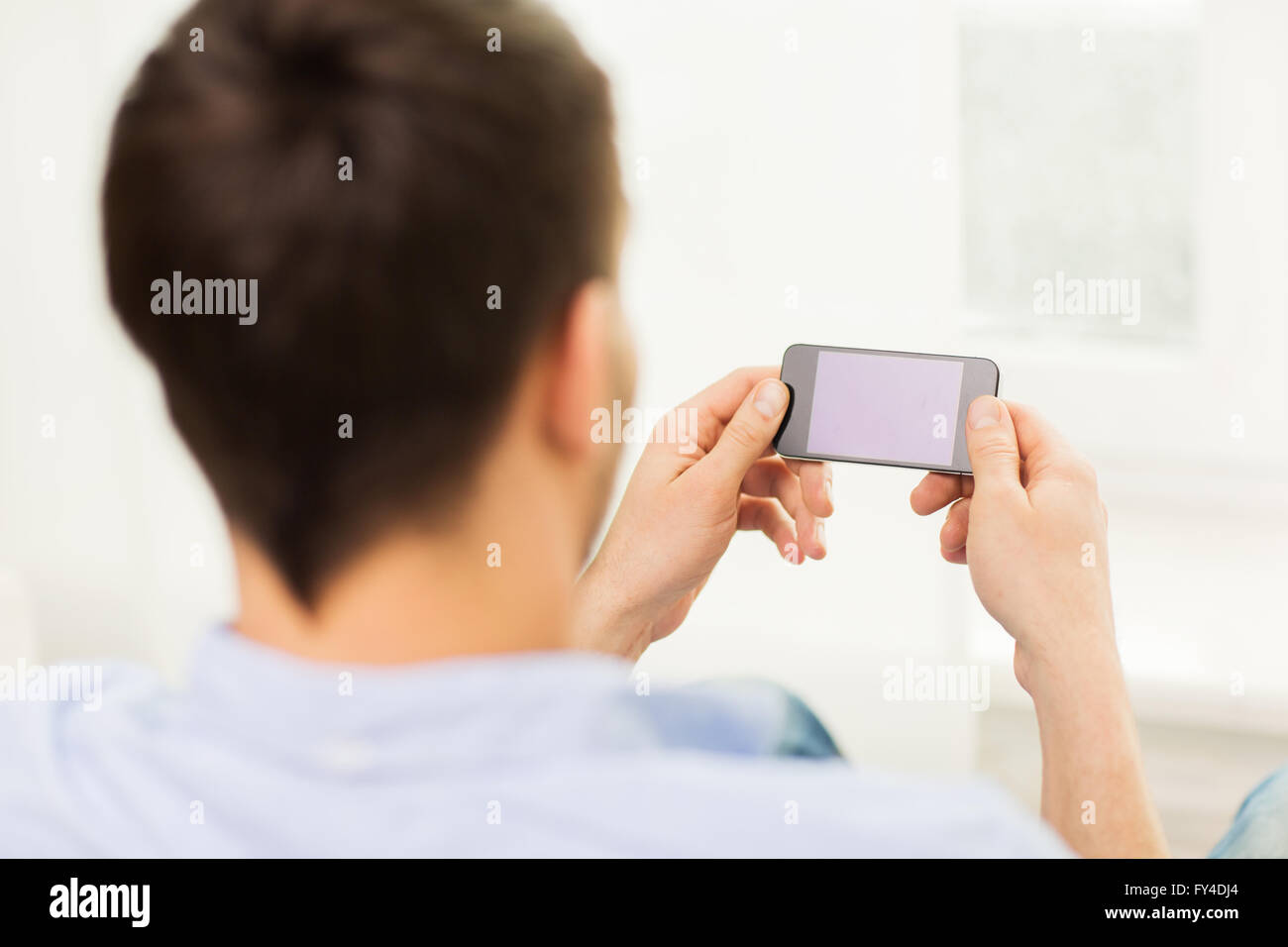 Man hand phone home rear hi-res stock photography and images - Alamy