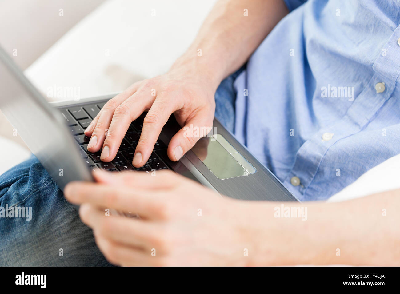 close up of man typing on laptop computer at home Stock Photo - Alamy