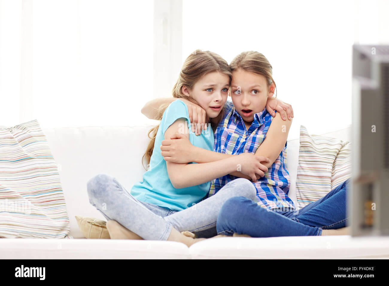 scared little girls watching horror on tv at home Stock Photo - Alamy