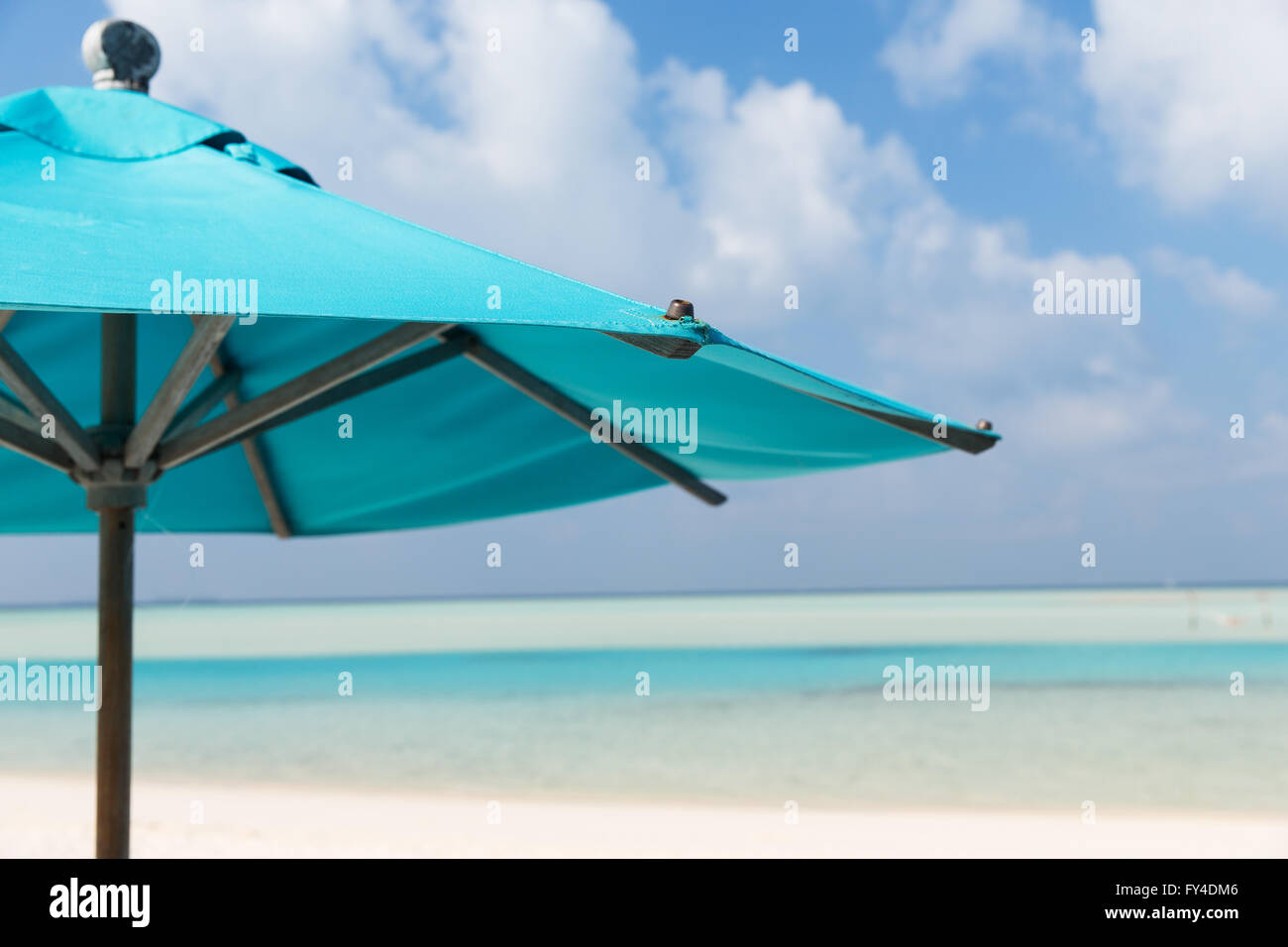 parasol over blue sky and beach Stock Photo - Alamy