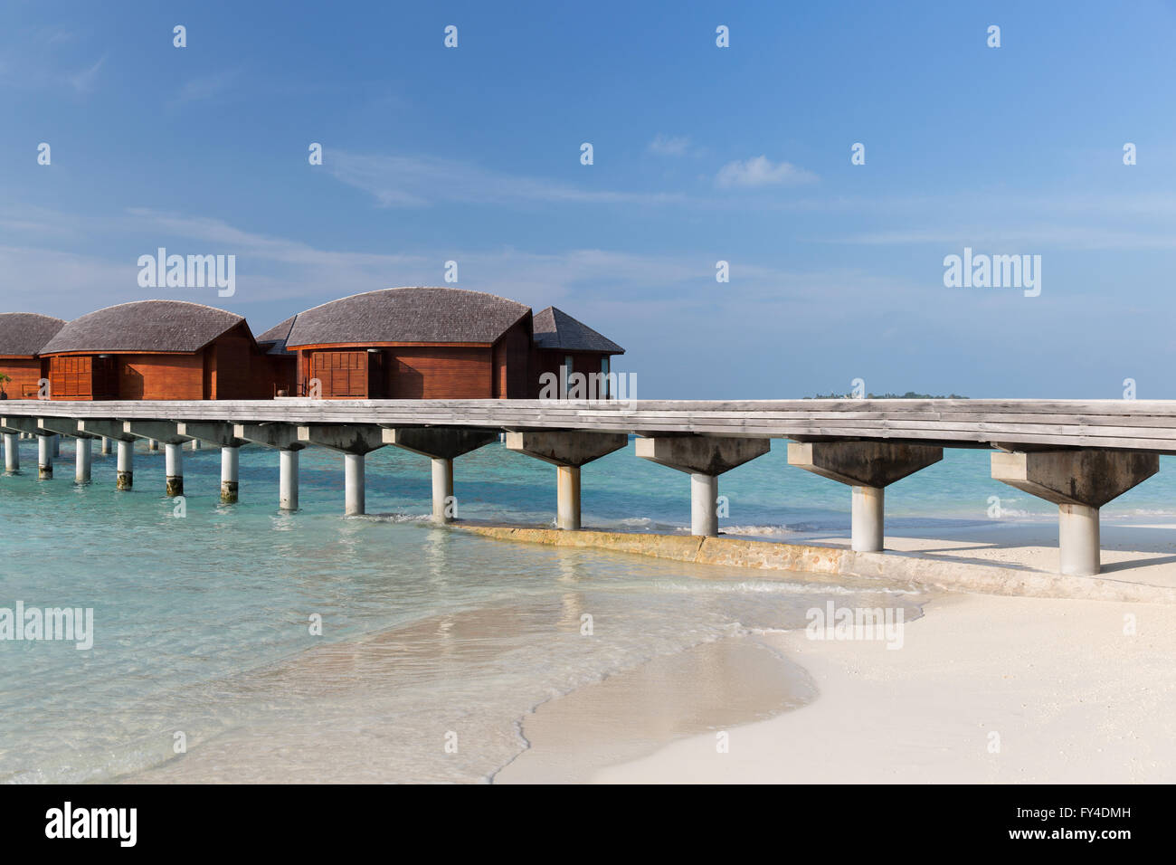 bungalow huts in sea water on exotic resort beach Stock Photo - Alamy