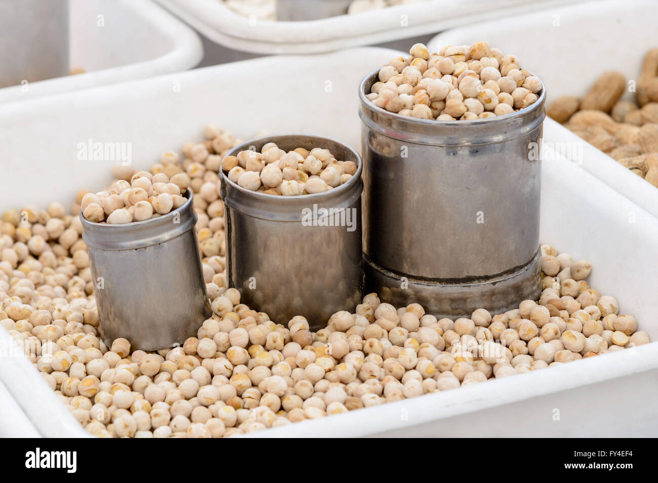 Close Up of the sales counter of peanuts with small tin cans Stock ...