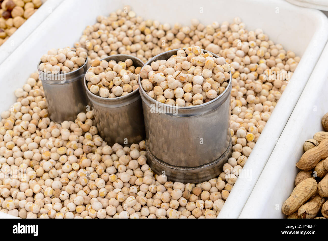 Close Up of the sales counter of peanuts with small tin cans Stock ...